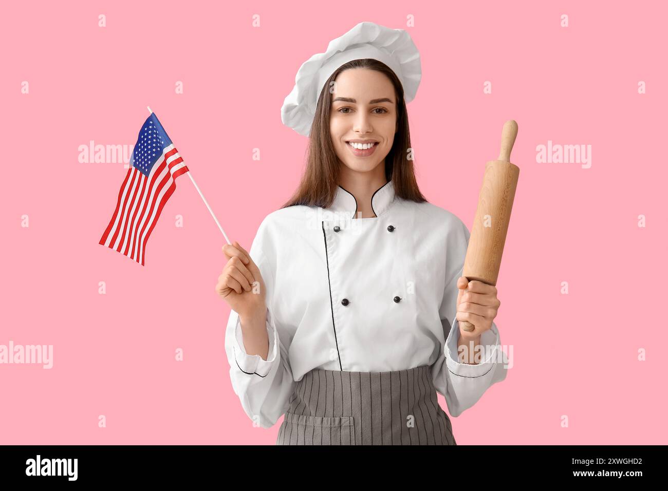 Female chef with USA flag and rolling pin on pink background Stock ...