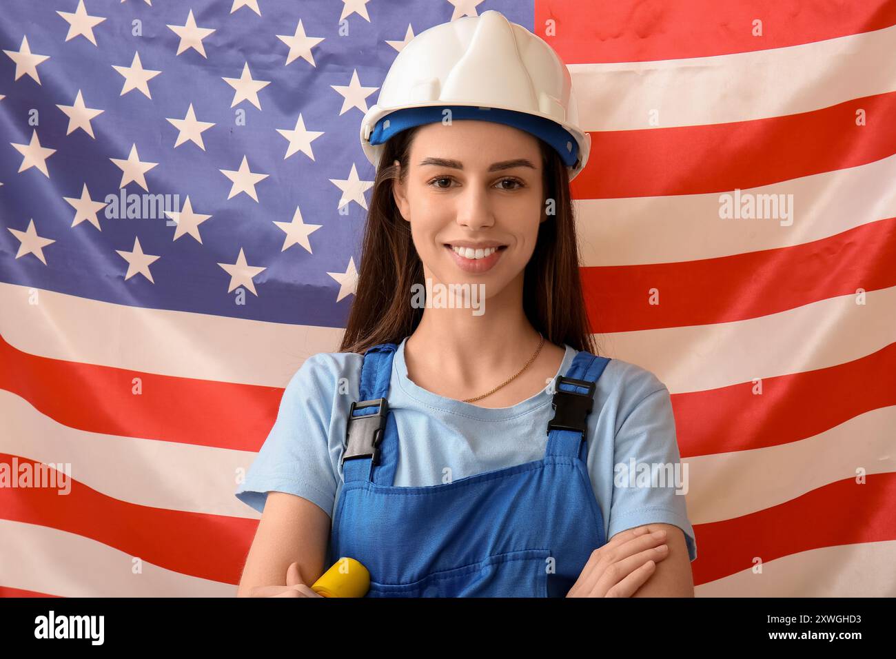 Female construction worker against USA flag background Stock Photo - Alamy