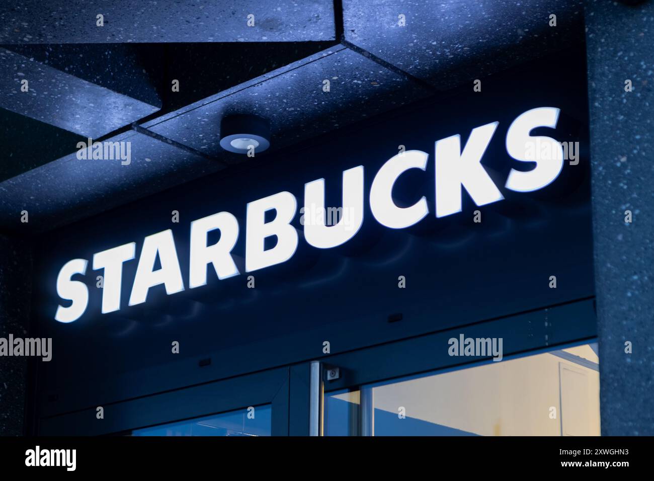 Poznan, Poland. 13 August, 2024: Illuminated Starbucks Storefront Sign ...