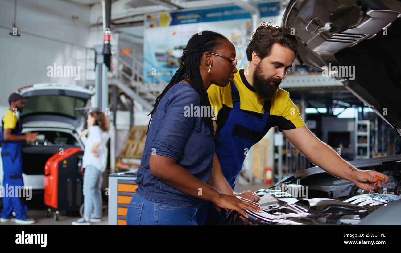 Engineers working together fix car hi-res stock photography and images ...