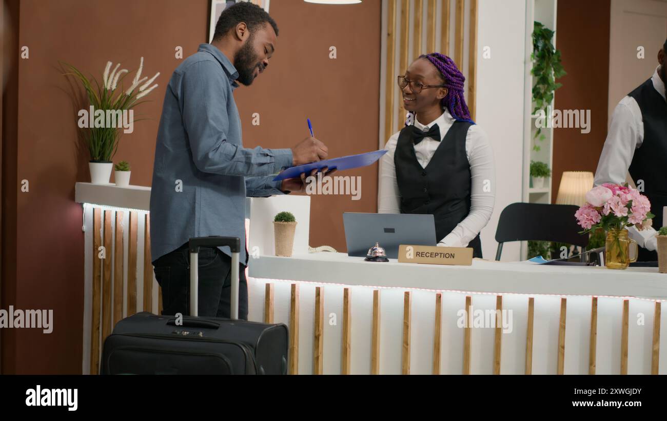Guest filling in registration forms hi-res stock photography and images ...