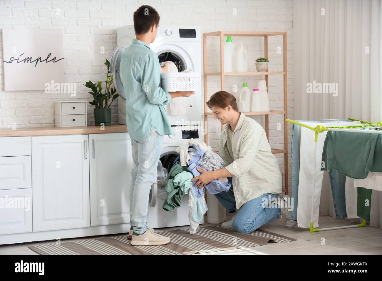Male students doing laundry in dormitory Stock Photo - Alamy