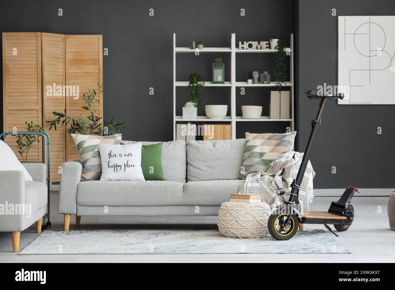 Interior of living room with electric scooter and sofas Stock Photo - Alamy