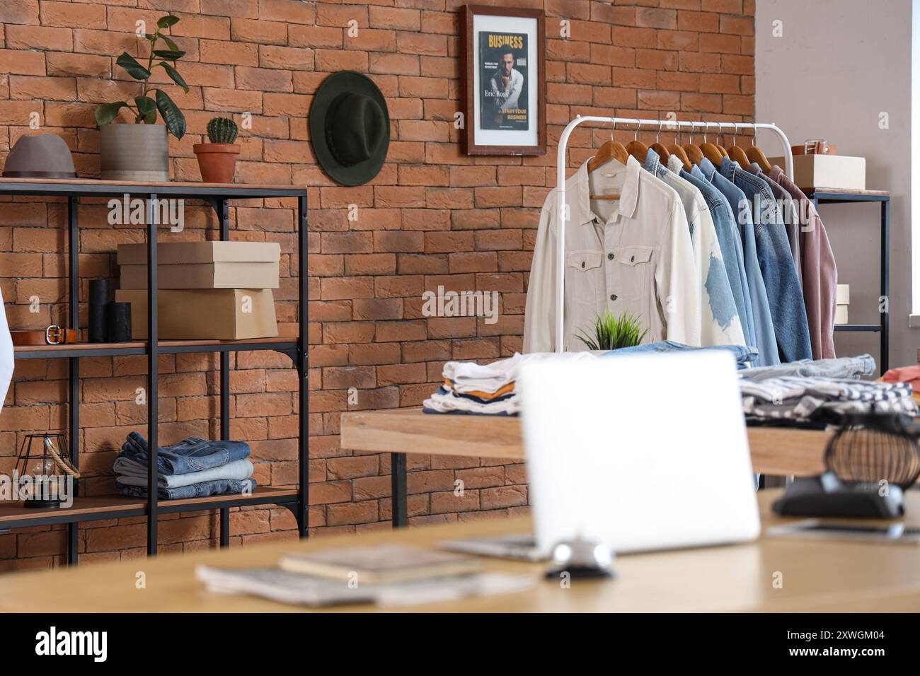 Interior of men's clothing store with rack and shelf unit Stock Photo ...