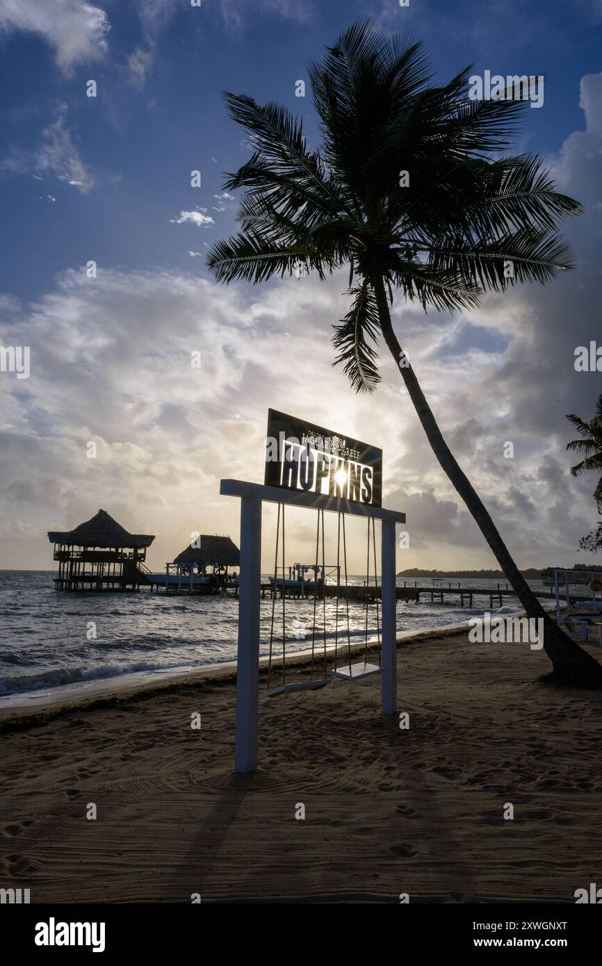 Sun Shining Through Resort Sign, Hopkins, Belize Stock Photo - Alamy