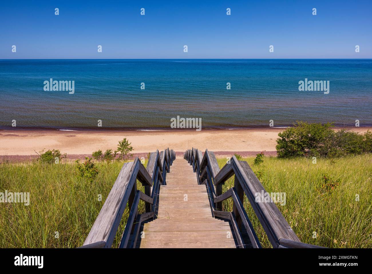 Wooden stairs leading down to a sandy beach along Great Lake Superior ...