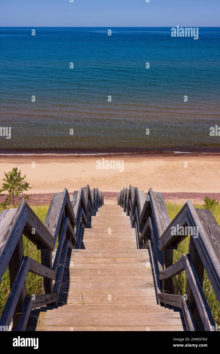 Wooden stairs leading down to a sandy beach along Great Lake Superior ...