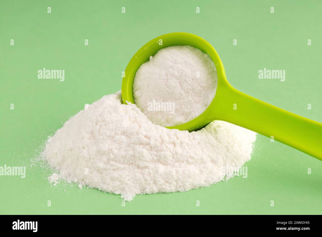 Baking Soda - Crystalline Solid compound in spoon. Green background ...