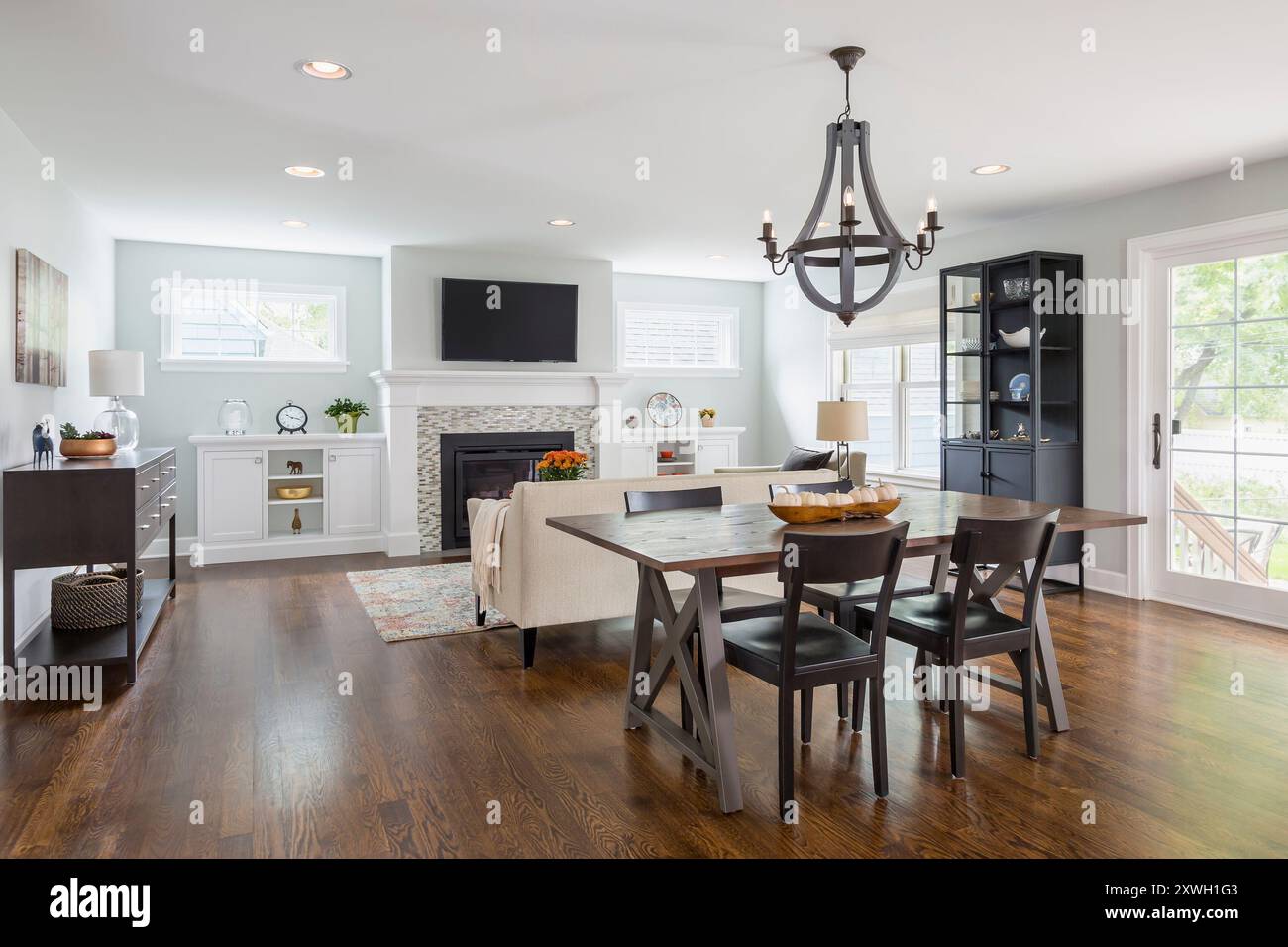 Light and airy living room with soft blue gray walls and dark wood ...