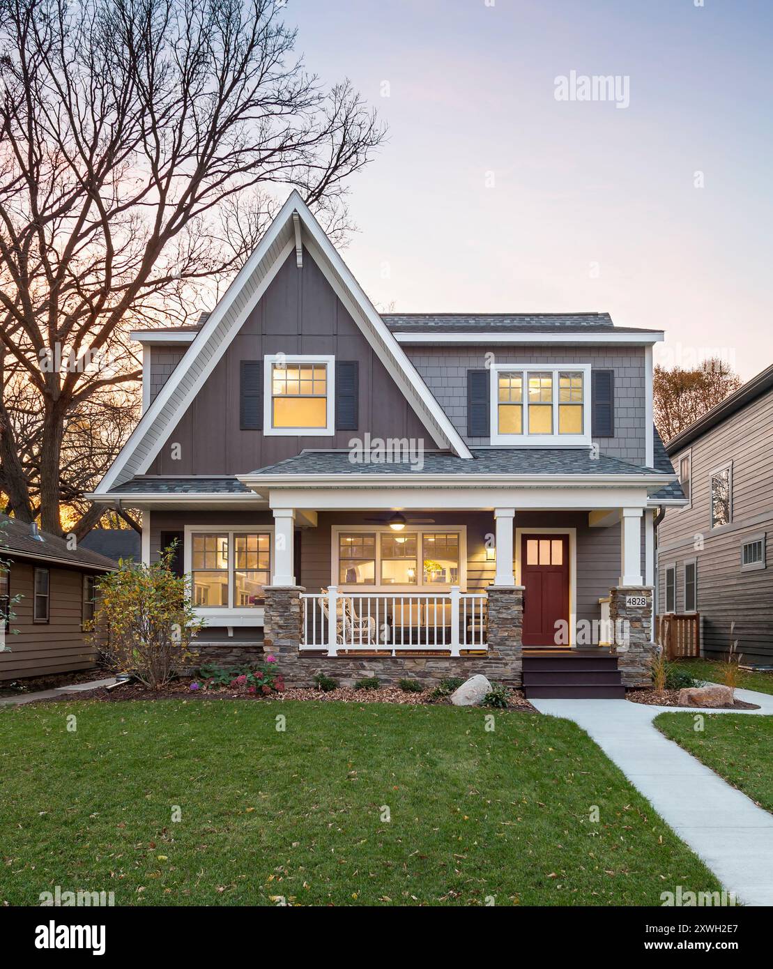 New house with gray siding and large open front porch viewed from ...
