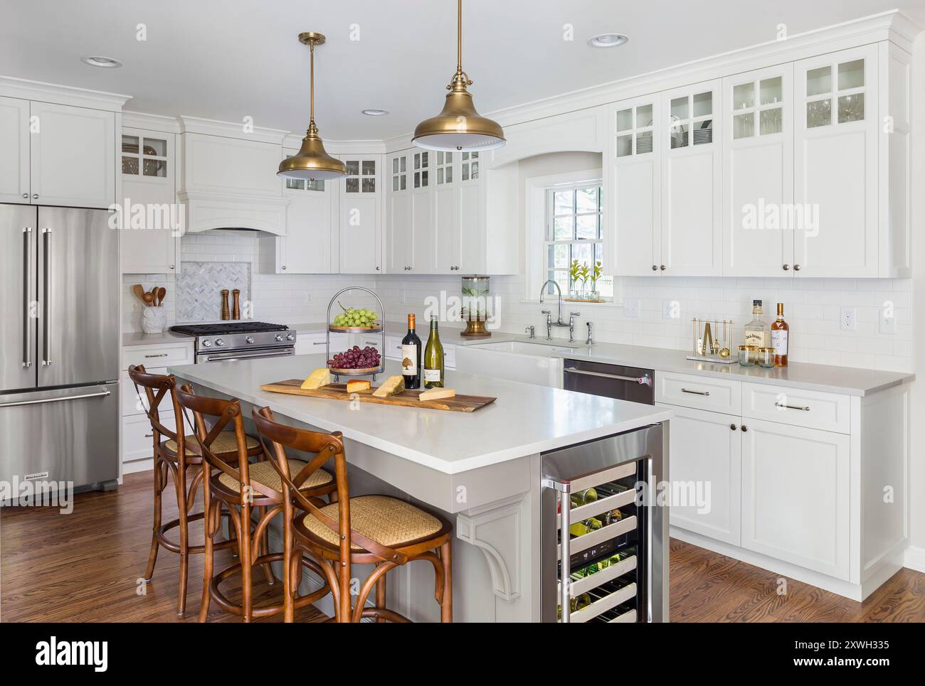 White kitchen with gray island and wine cooler built into island Stock ...