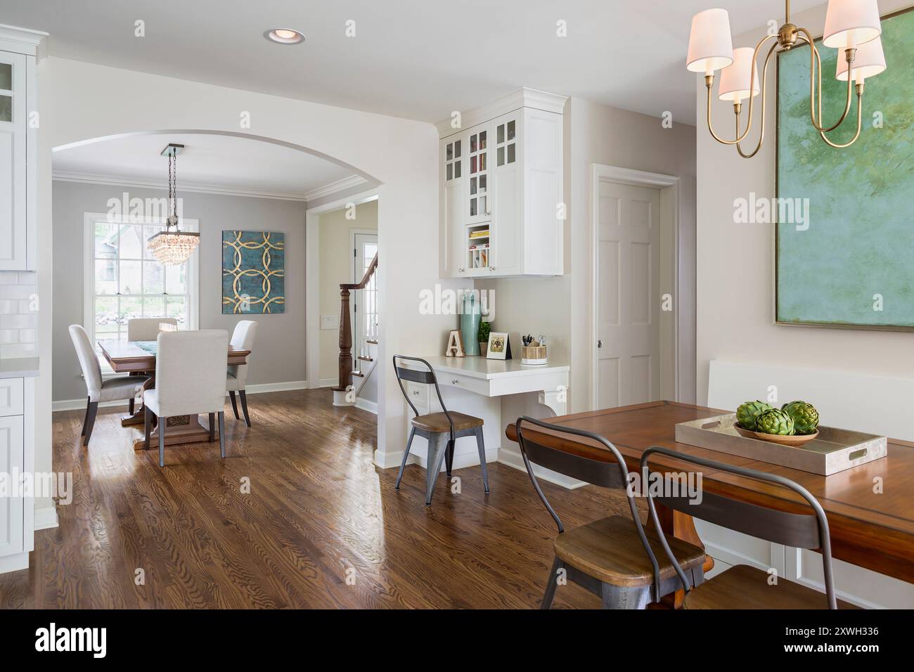 Kitchen table and built-in desk in kitchen area looking through archway ...