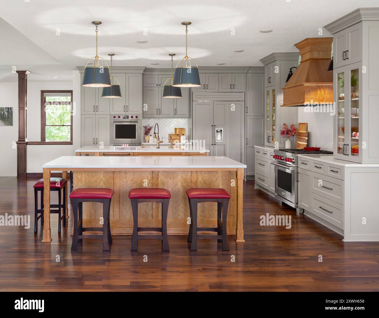 Large kitchen with gray cabinets and two cherry wood kitchen islands ...