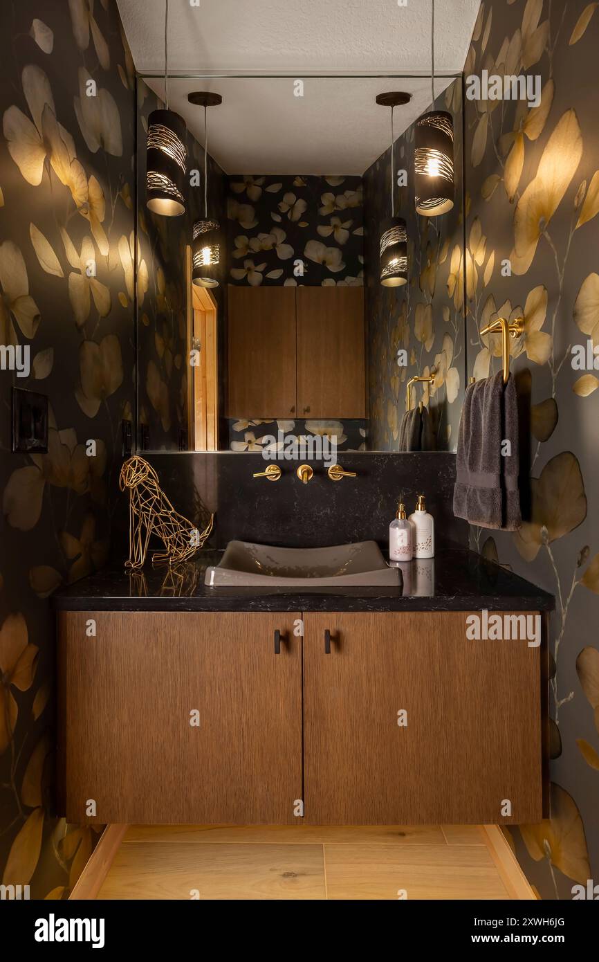 Powder room with dark floral wallpaper with gold accents and dark gray ...
