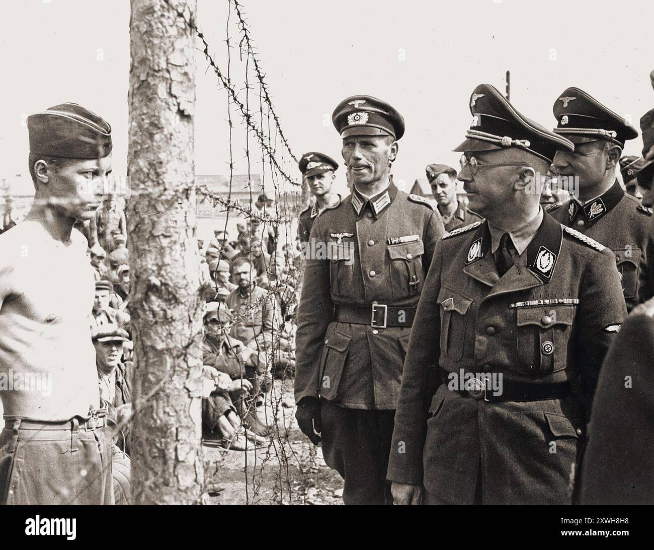 Heinrich Himmler looks at a young Soviet prisoner during an official ...