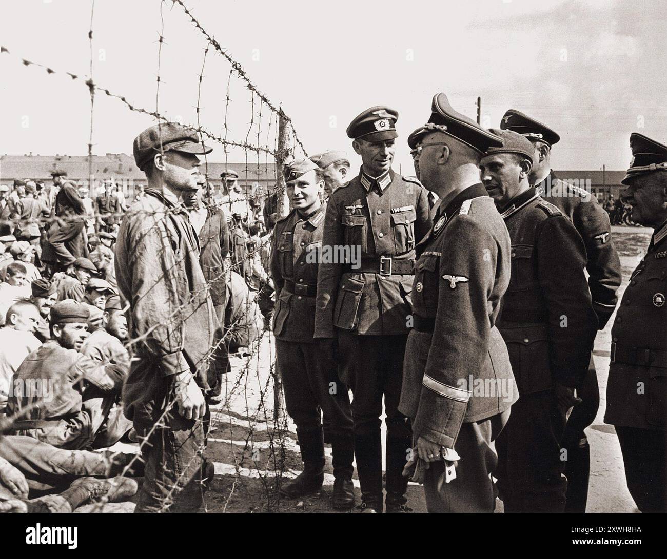 Heinrich Himmler looks at a young Soviet prisoner during an official ...
