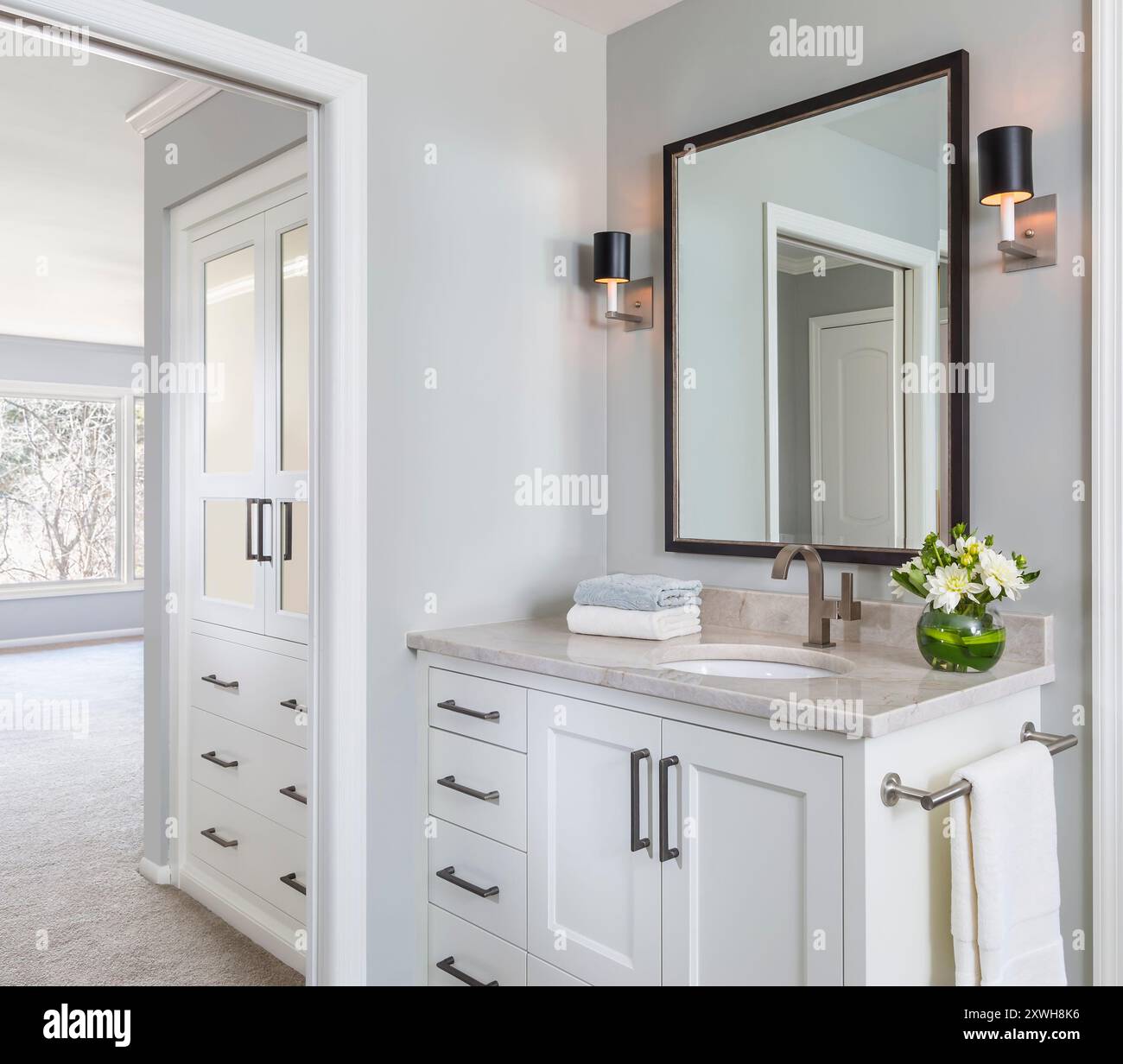 Bathroom vanity with linen closet just outside doorway Stock Photo - Alamy