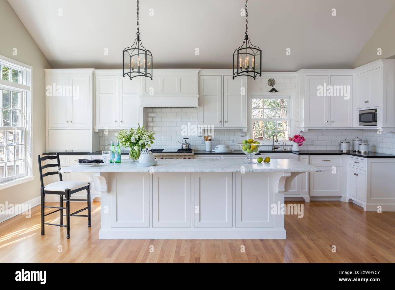 Beautiful large white kitchen with traditional cabinets and black ...