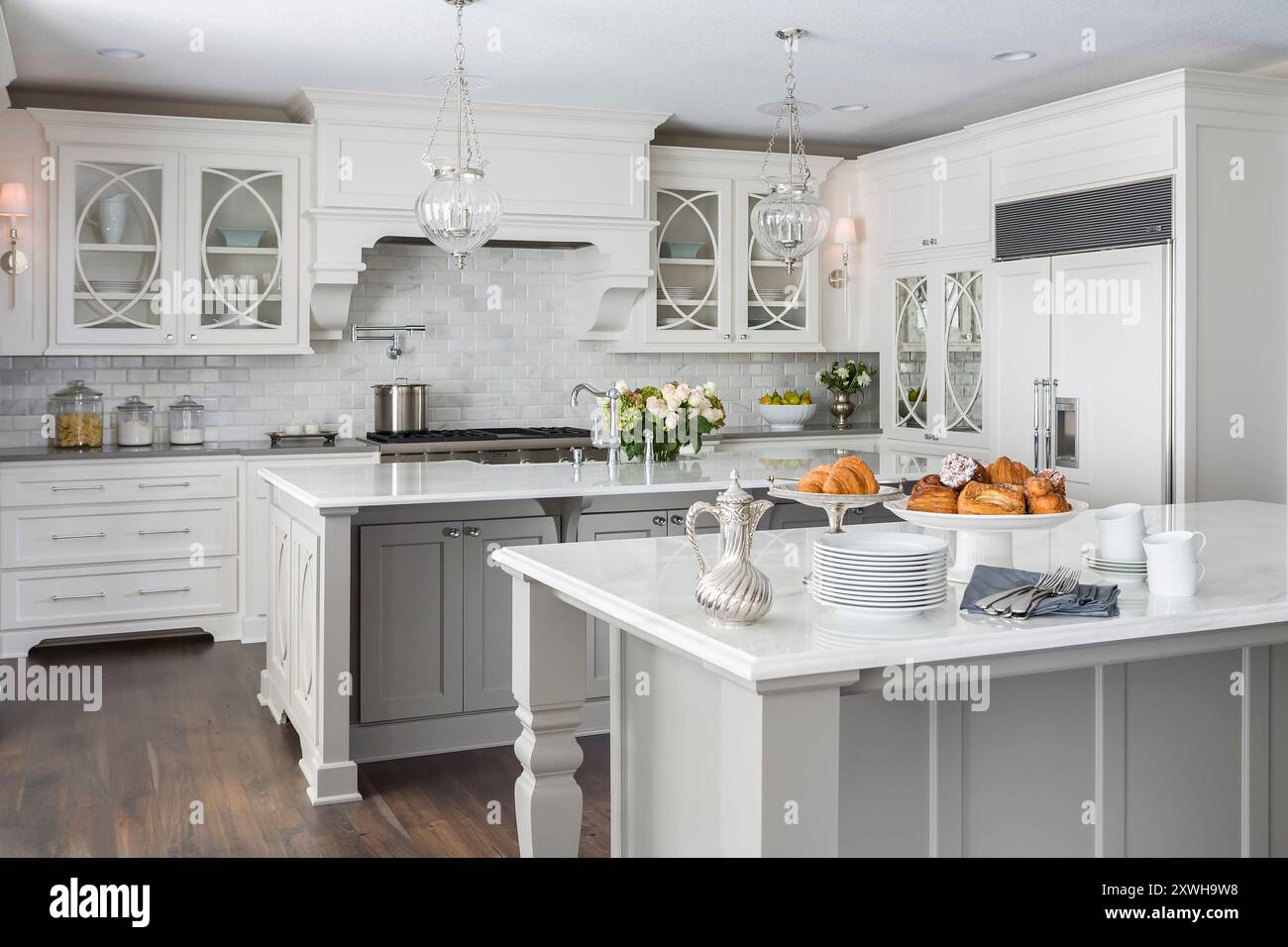 Beautiful high end white kitchen with two islands seen from angle Stock ...