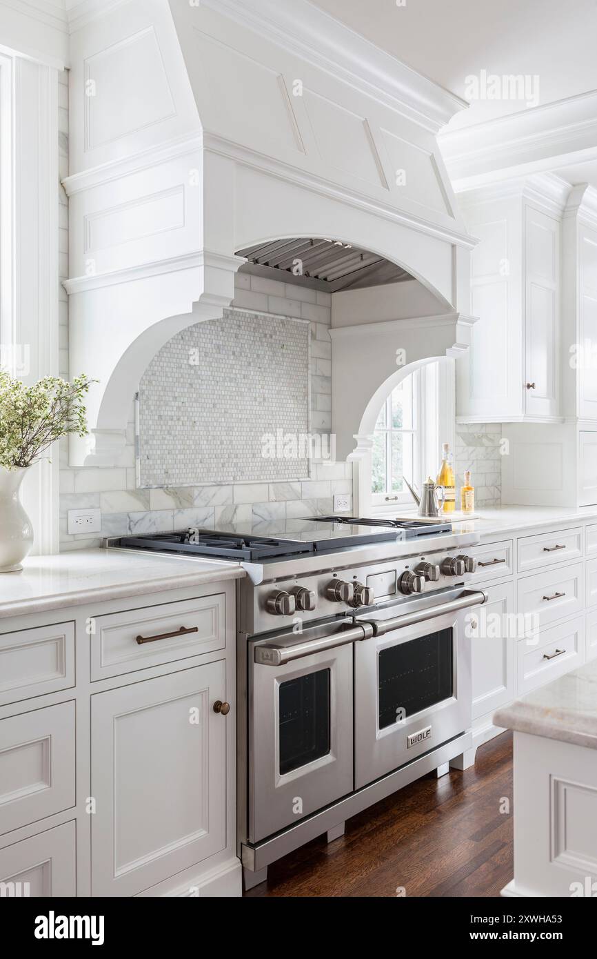 Wolf range in beautiful white kitchen with Wolf hood vent in custom ...