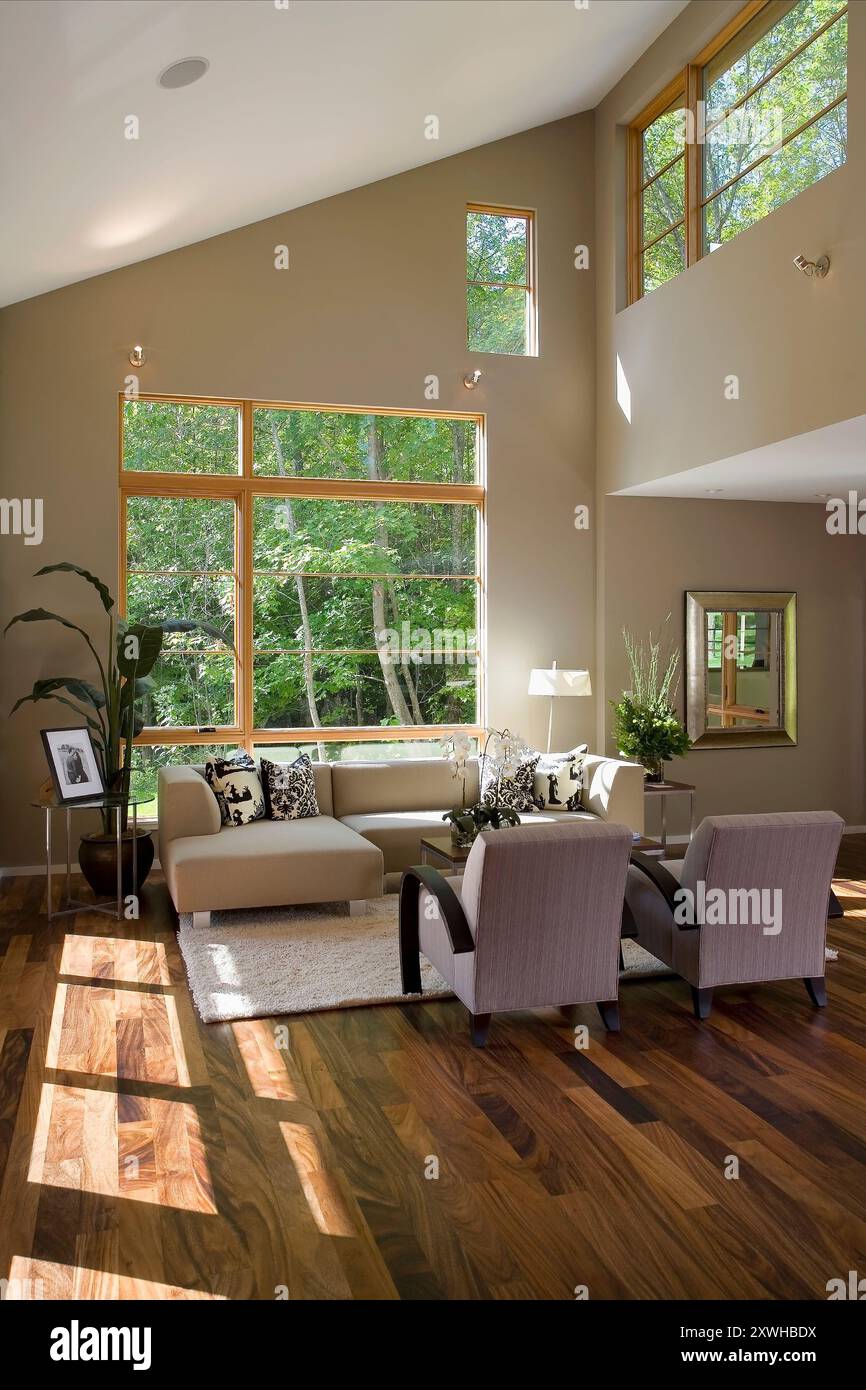 Corner of living room with large windows at multiple levels looking out ...