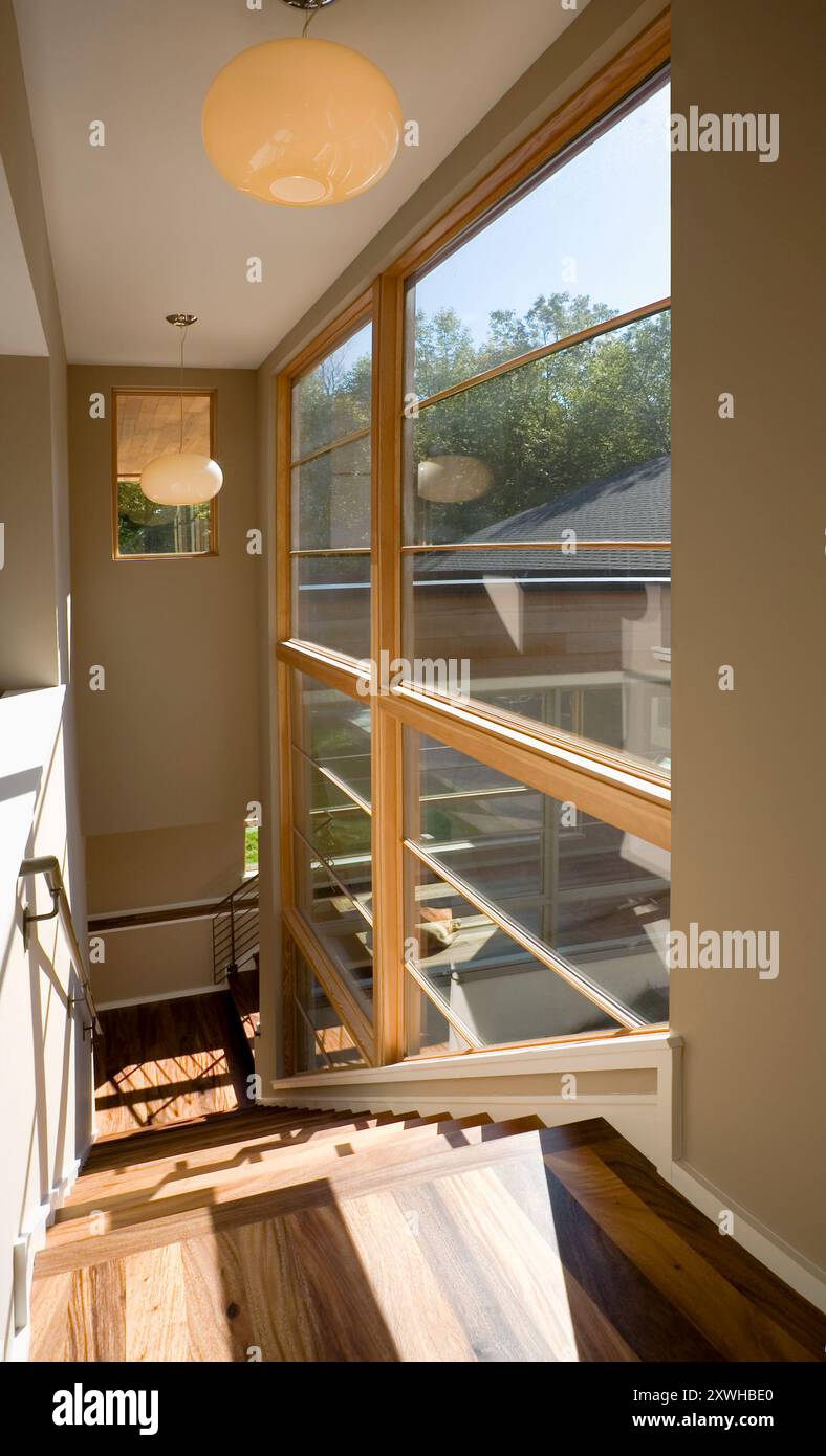 Five windows fit into triangular shape of wall by stairs hi-res stock ...