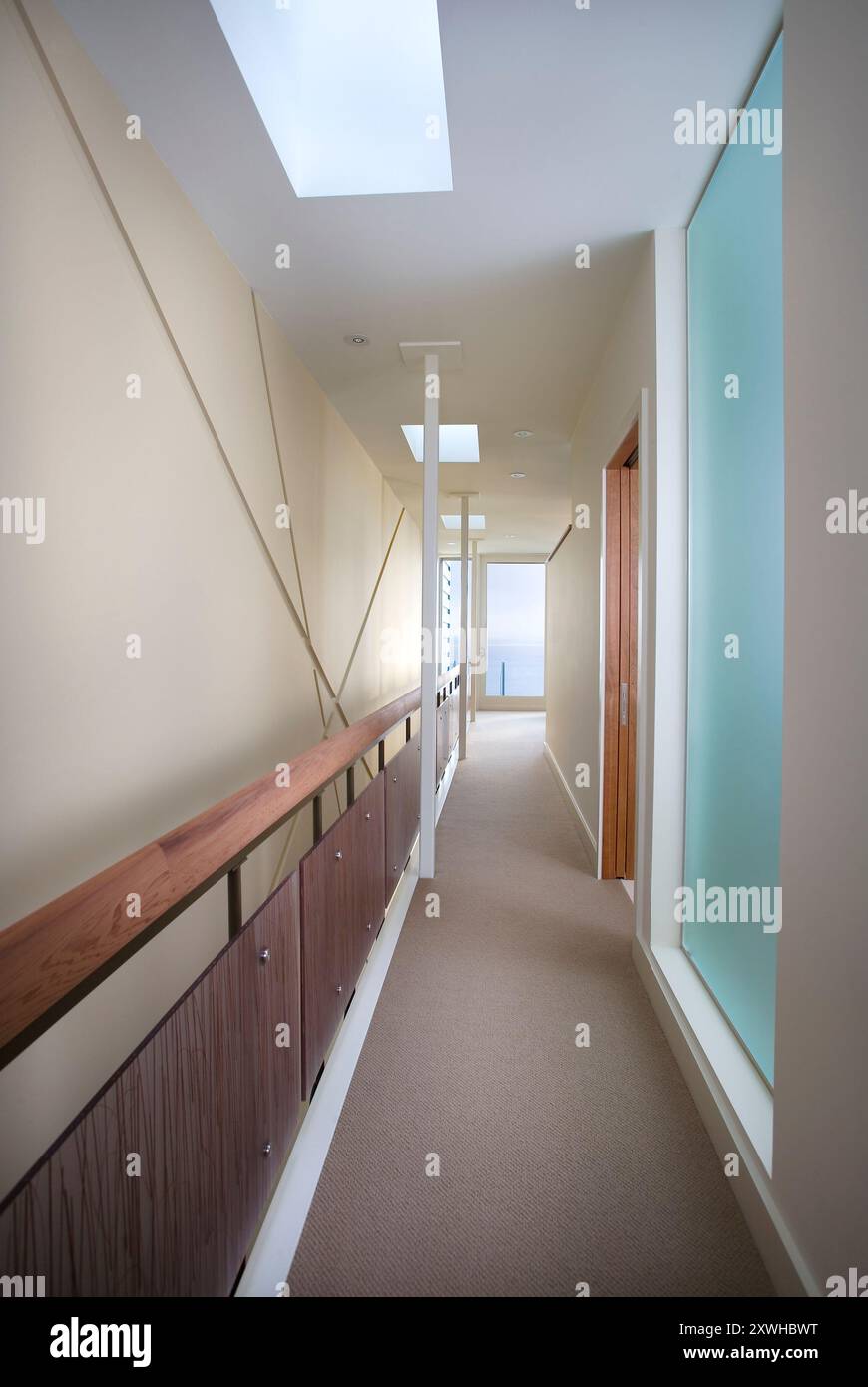 Hallway of modern apartment with view of Lake Superior at end doorway ...