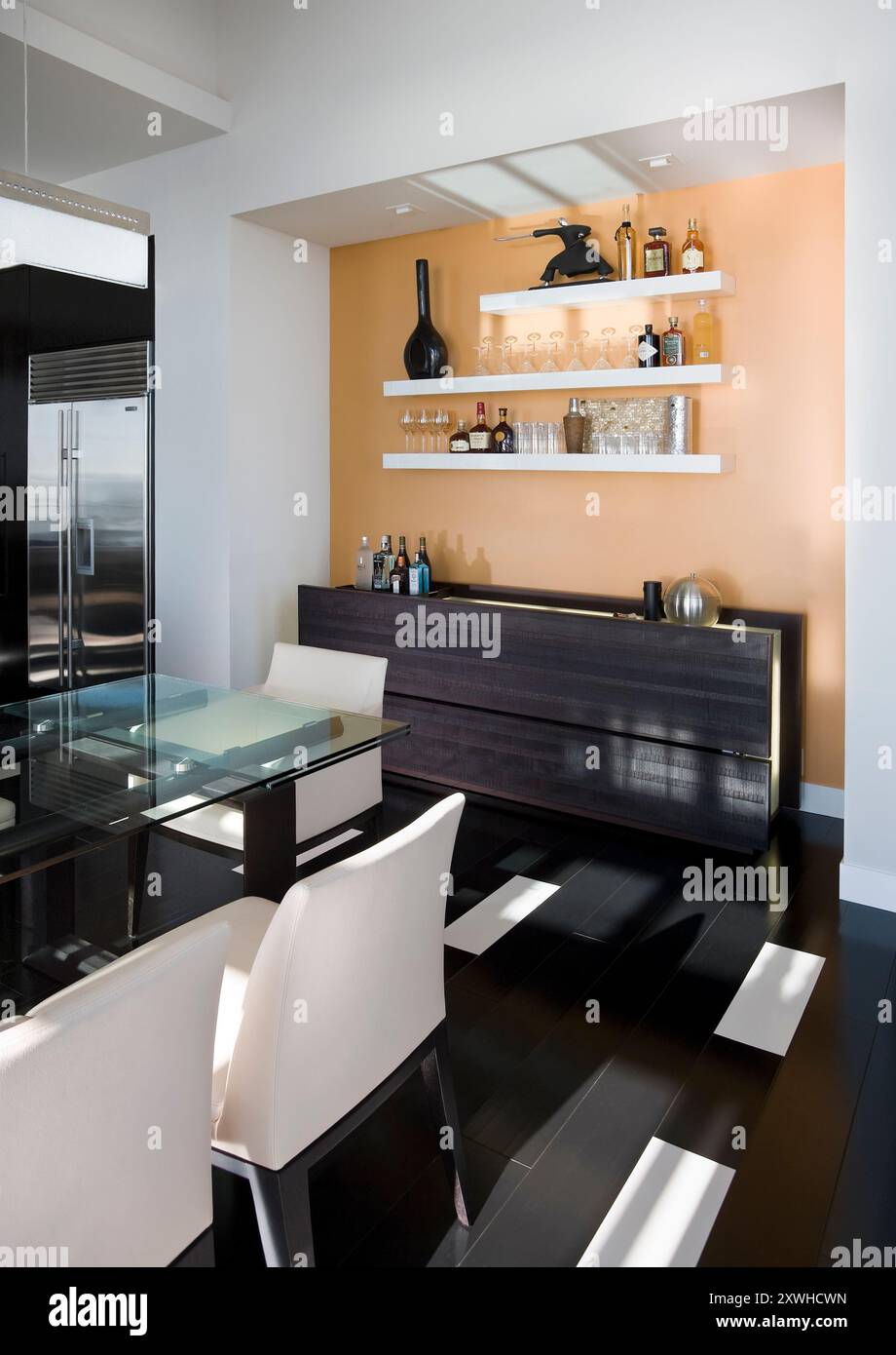 Modern dining room with glass table and bar area Stock Photo - Alamy