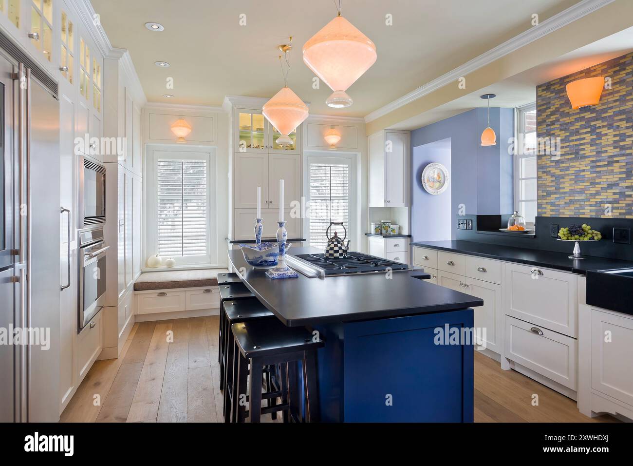 Beautiful high end kitchen with white cabinets, blue walls and black ...