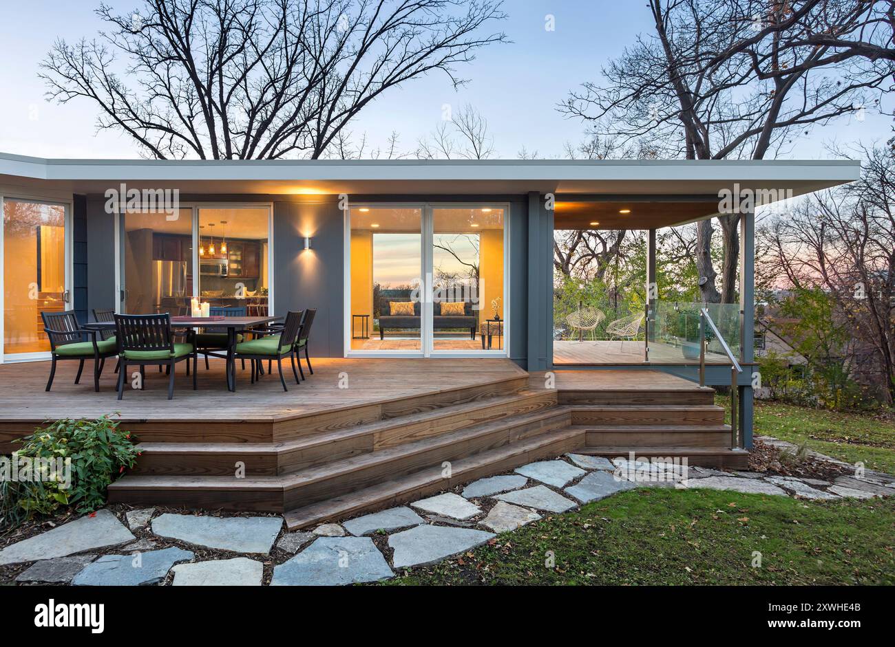 Exterior of new addition to house showing large deck and see-through ...