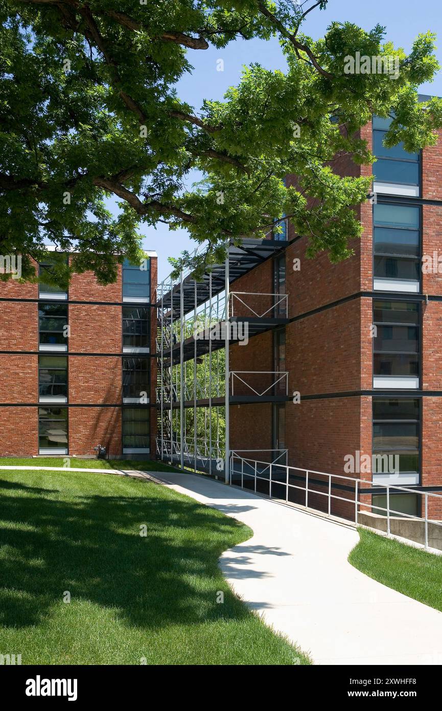modern multi-storied walkway connection between two red brick buildings ...
