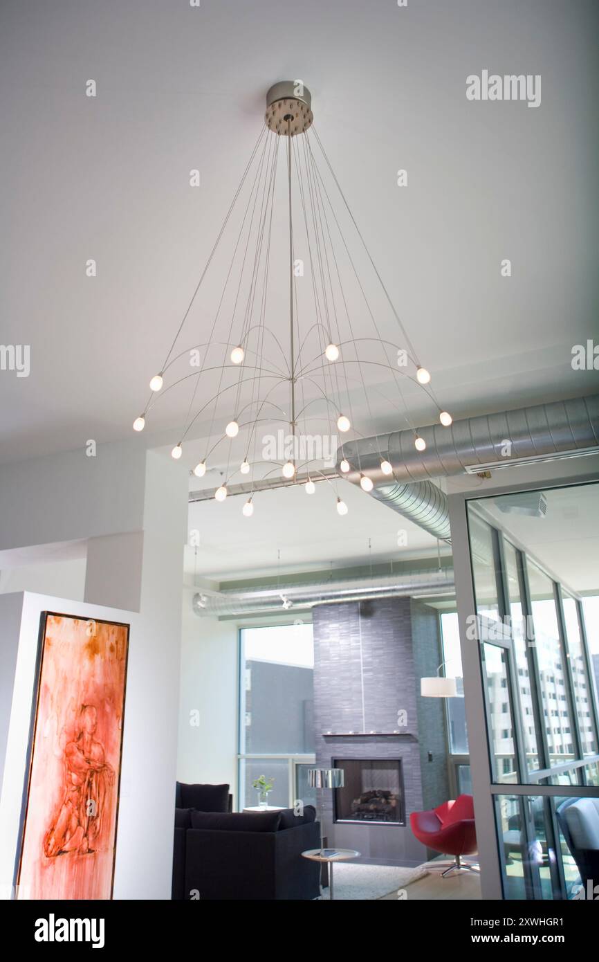 Modern light fixture with modern living space in background Stock Photo ...