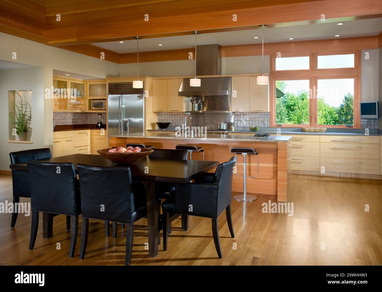 Modern kitchen showing island and dining table and chairs Stock Photo ...