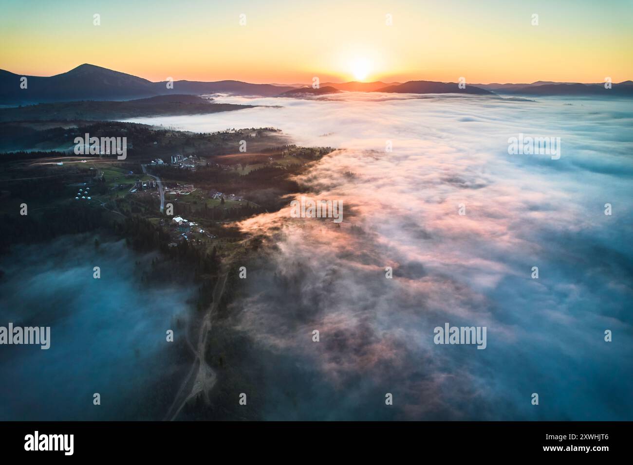 Stunning aerial view of sunrise over mountainous landscape, with thick ...