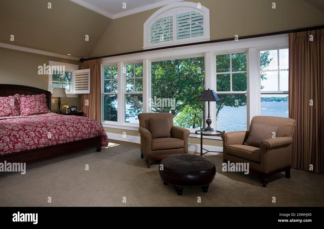 Bedroom with large windows with view of lake Stock Photo - Alamy