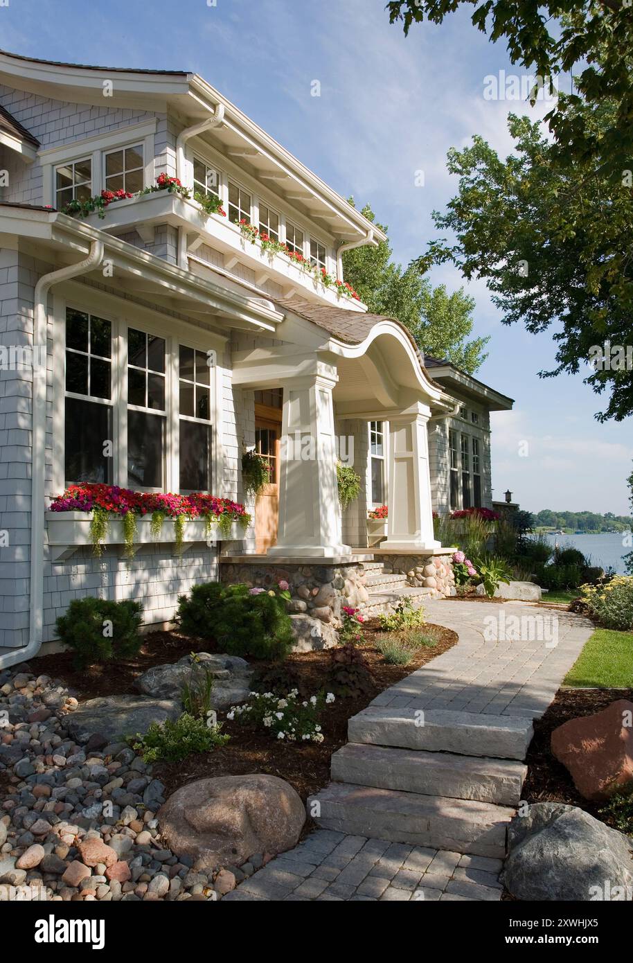 Exterior of large cottage style home on a lake Stock Photo - Alamy