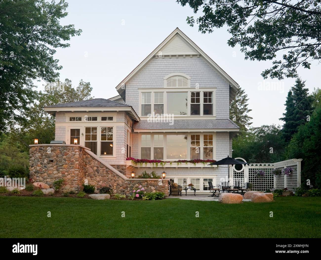 Exterior of large cottage style house showing stone steps and patio ...