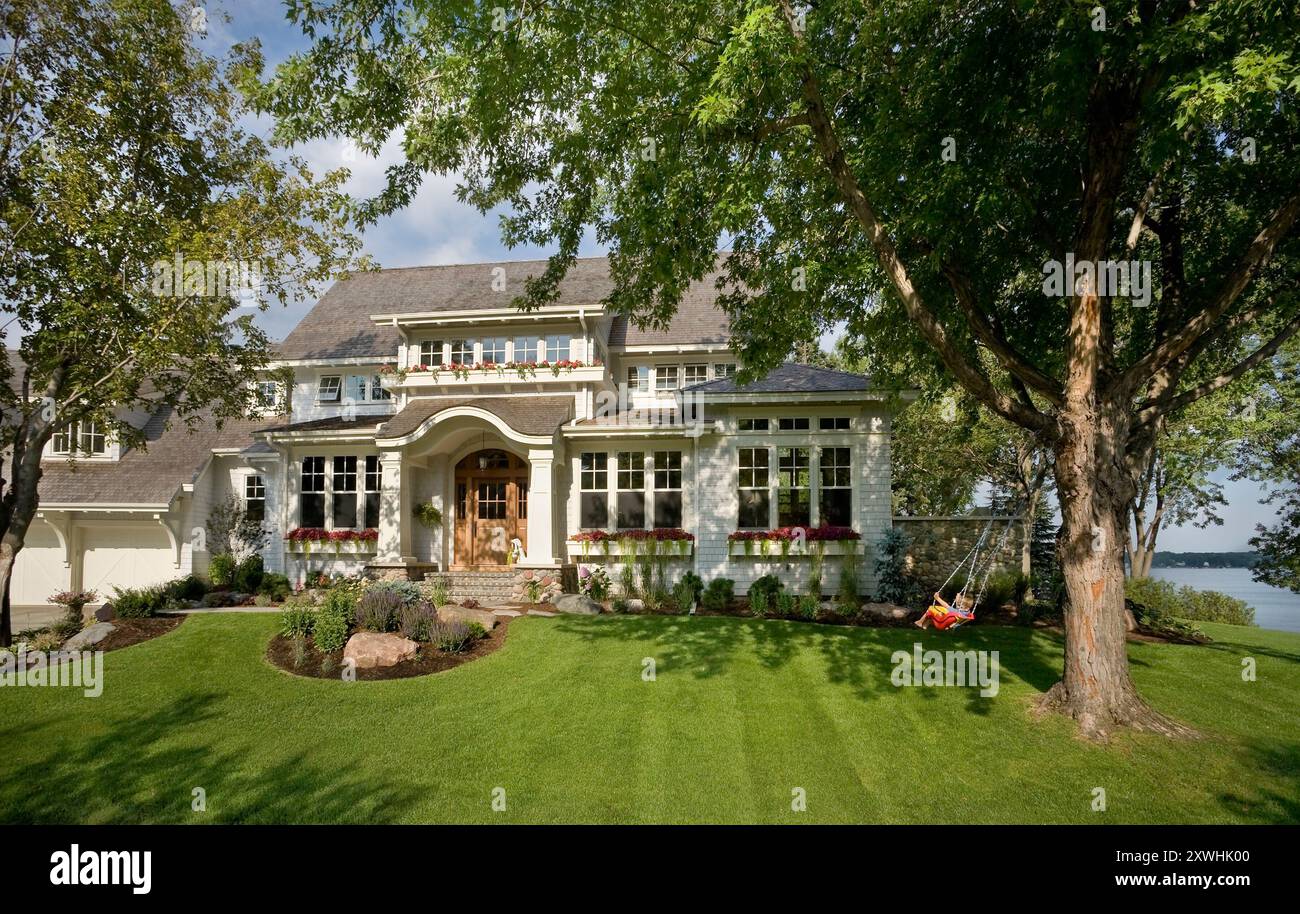 Exterior of large cottage style home on a lake Stock Photo - Alamy