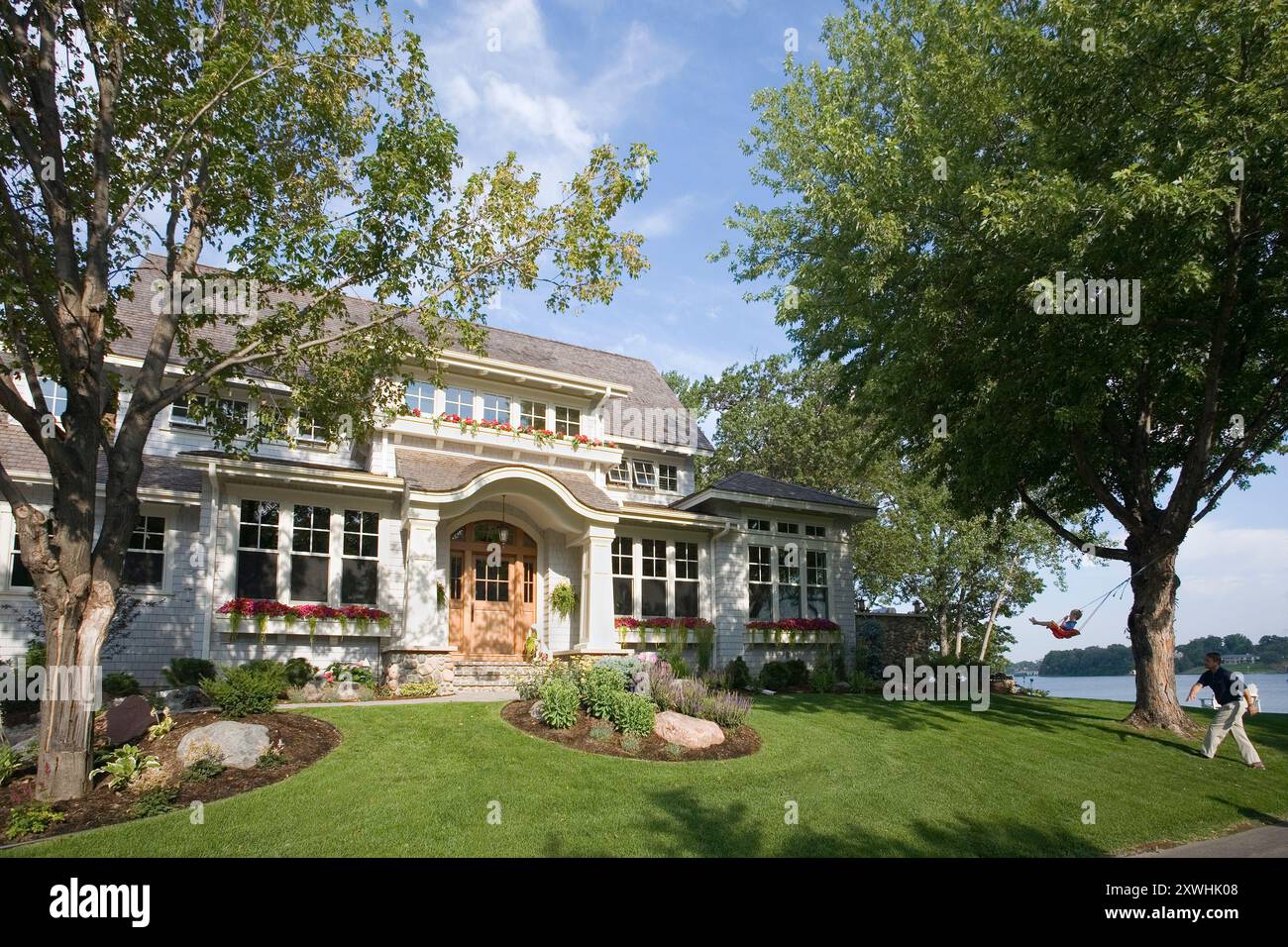 Exterior of large cottage style home on a lake Stock Photo - Alamy