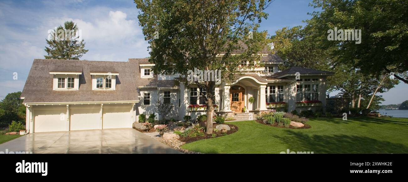 Exterior of large cottage style home on a lake Stock Photo - Alamy