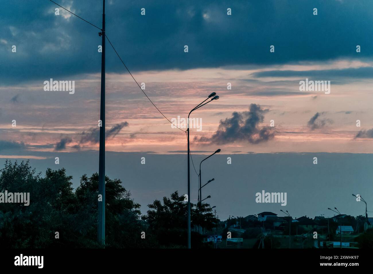 Sunset Sky Over Cityscape with Streetlights Stock Photo - Alamy