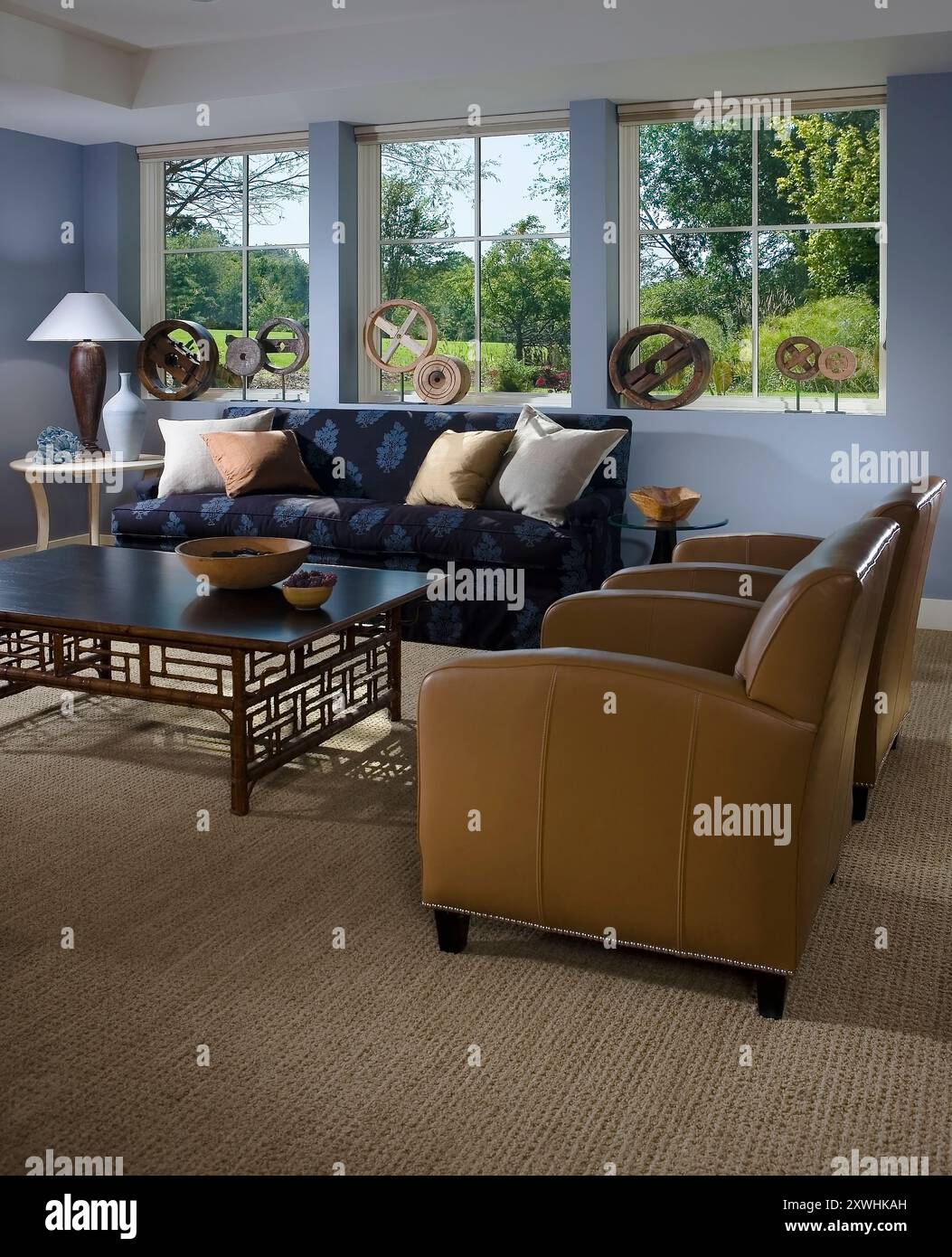 Blue family room with three windows looking outside to backyard Stock ...