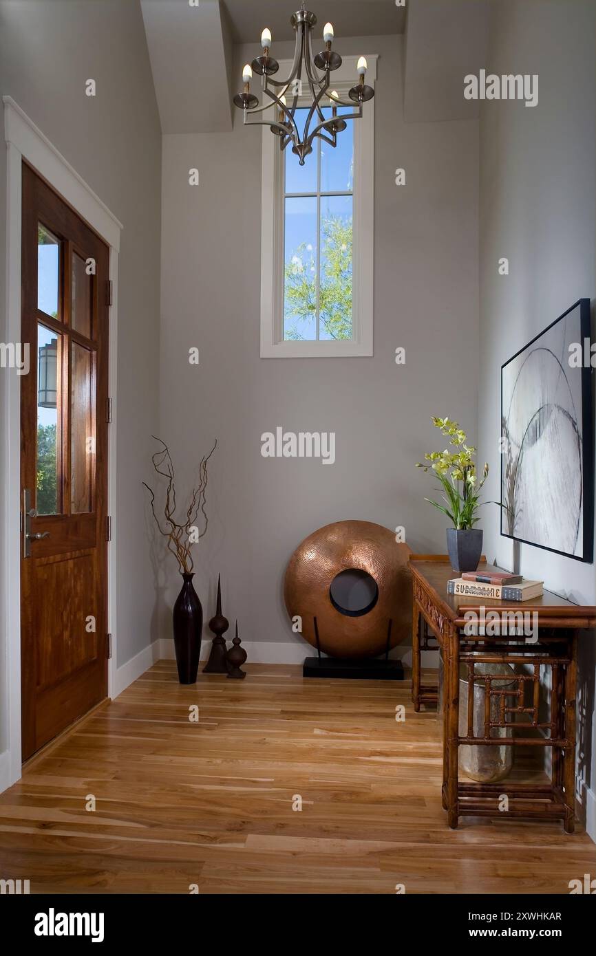 Front hallway of home with table and artwork with door closed Stock ...