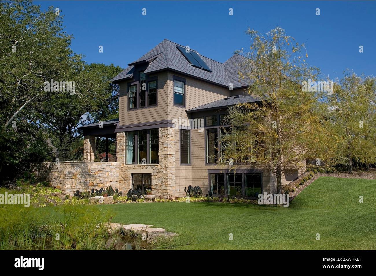 Back of new high end house showing landscaping, Hardi-Plank and stone ...