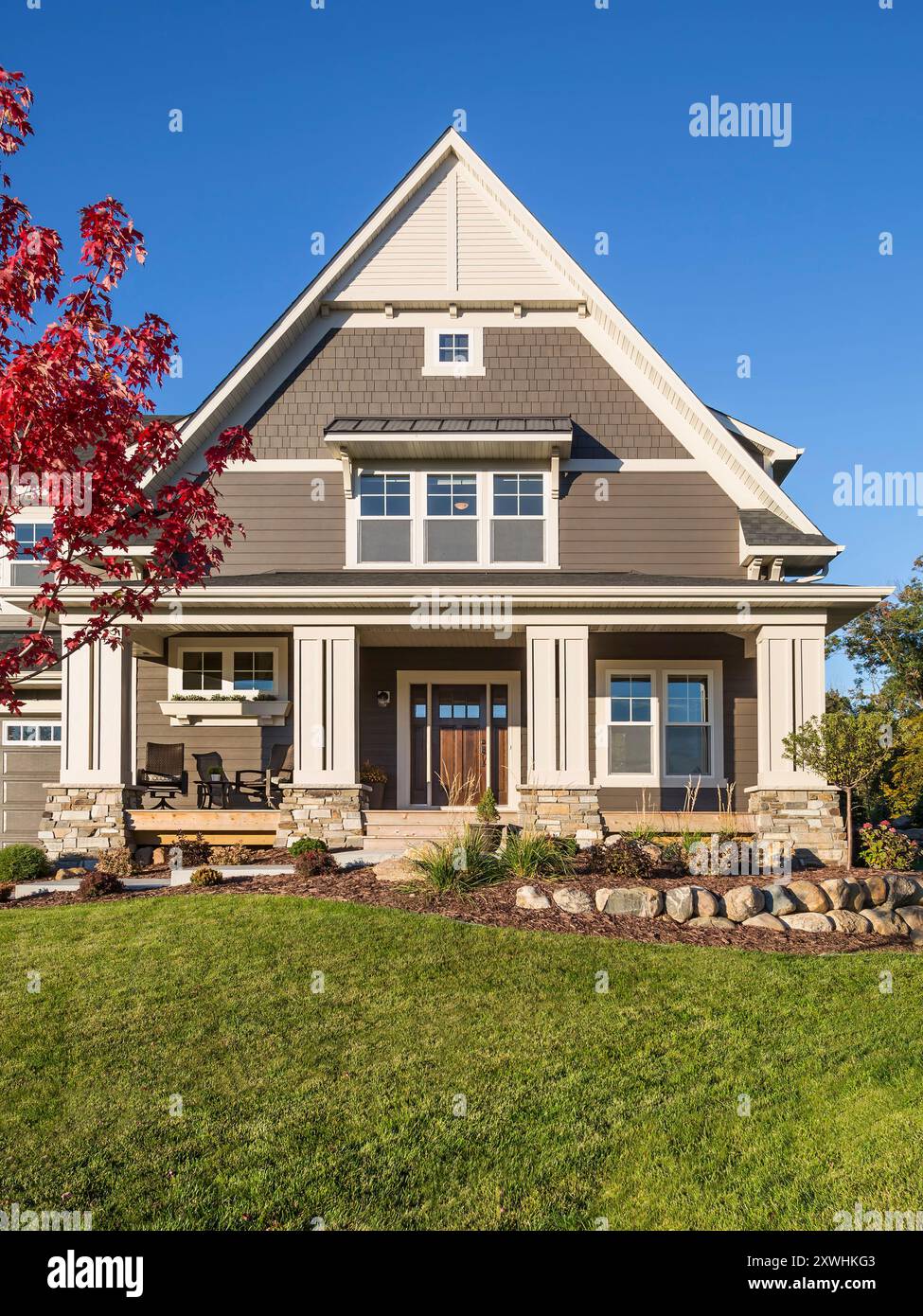 Warm gray house with white trim and large front gable and front porch ...