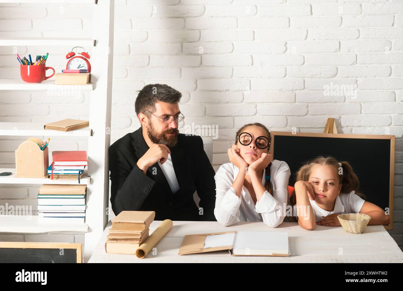 Little school girl and fether teacher with hold a books with school bag is back to school, empty ...