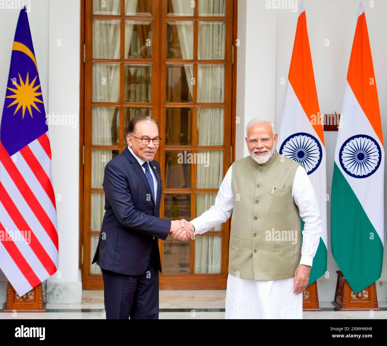 Indian Prime Minister Narendra Modi, right, shakes hand with his ...