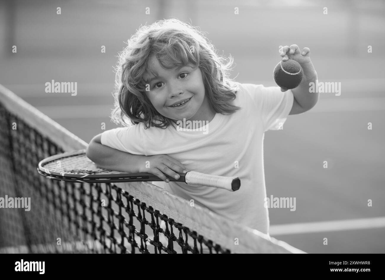 Child with tennis racket and tennis ball playing on tennis court Stock ...