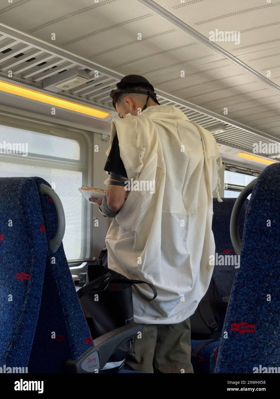 An Israeli soldier wrapped with a tallit and tefillin phylacteries ...