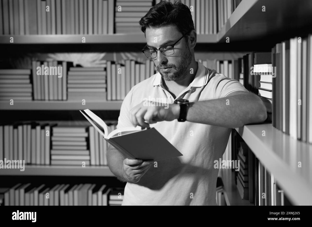 Portrait of professor with book in classroom. Handsome professor in ...